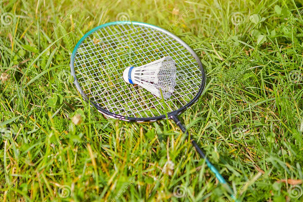 One Shuttlecock Along with Carbon Badminton Racket Placed on Lawn ...