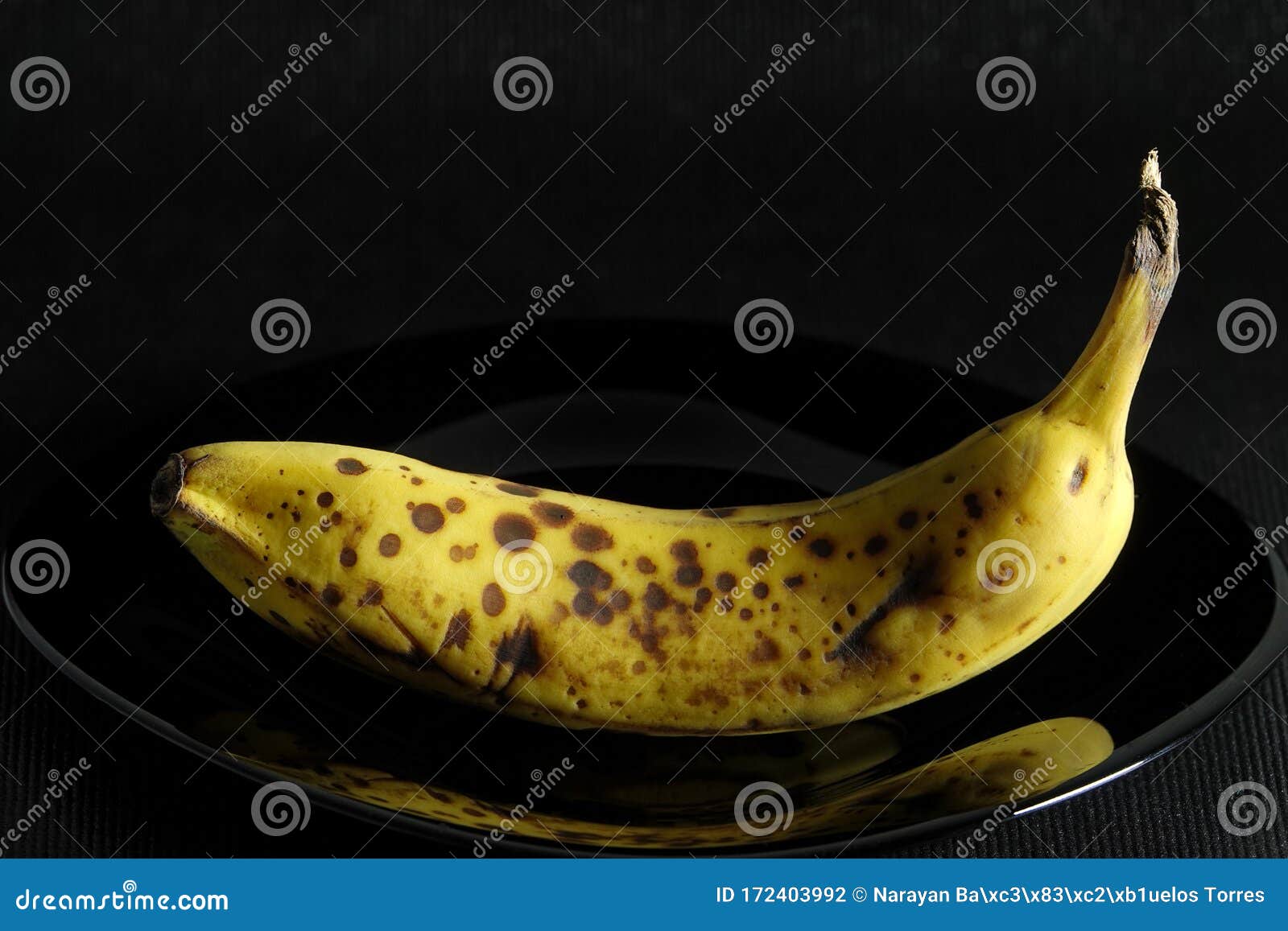 One Single Yellow Banana Isolated On Black Background Stock Photo ...