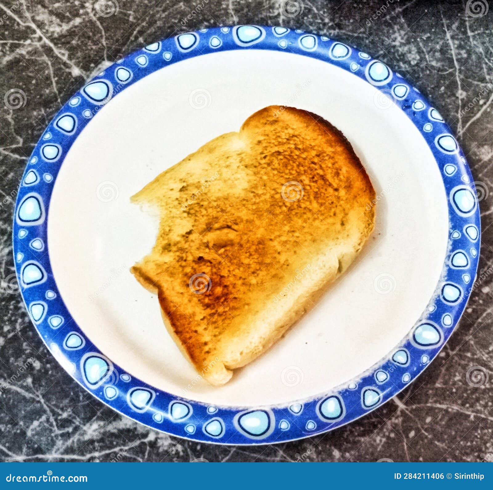 One Slice of Toast Had Bite Marks.the Word is on a White Plate with a ...