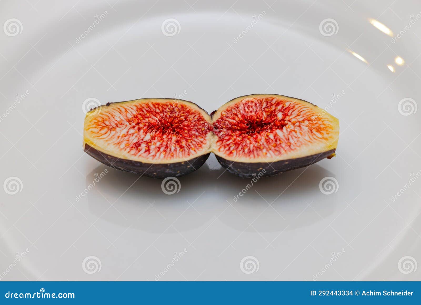 One sliced fig on a plate stock photo. Image of food - 292443334