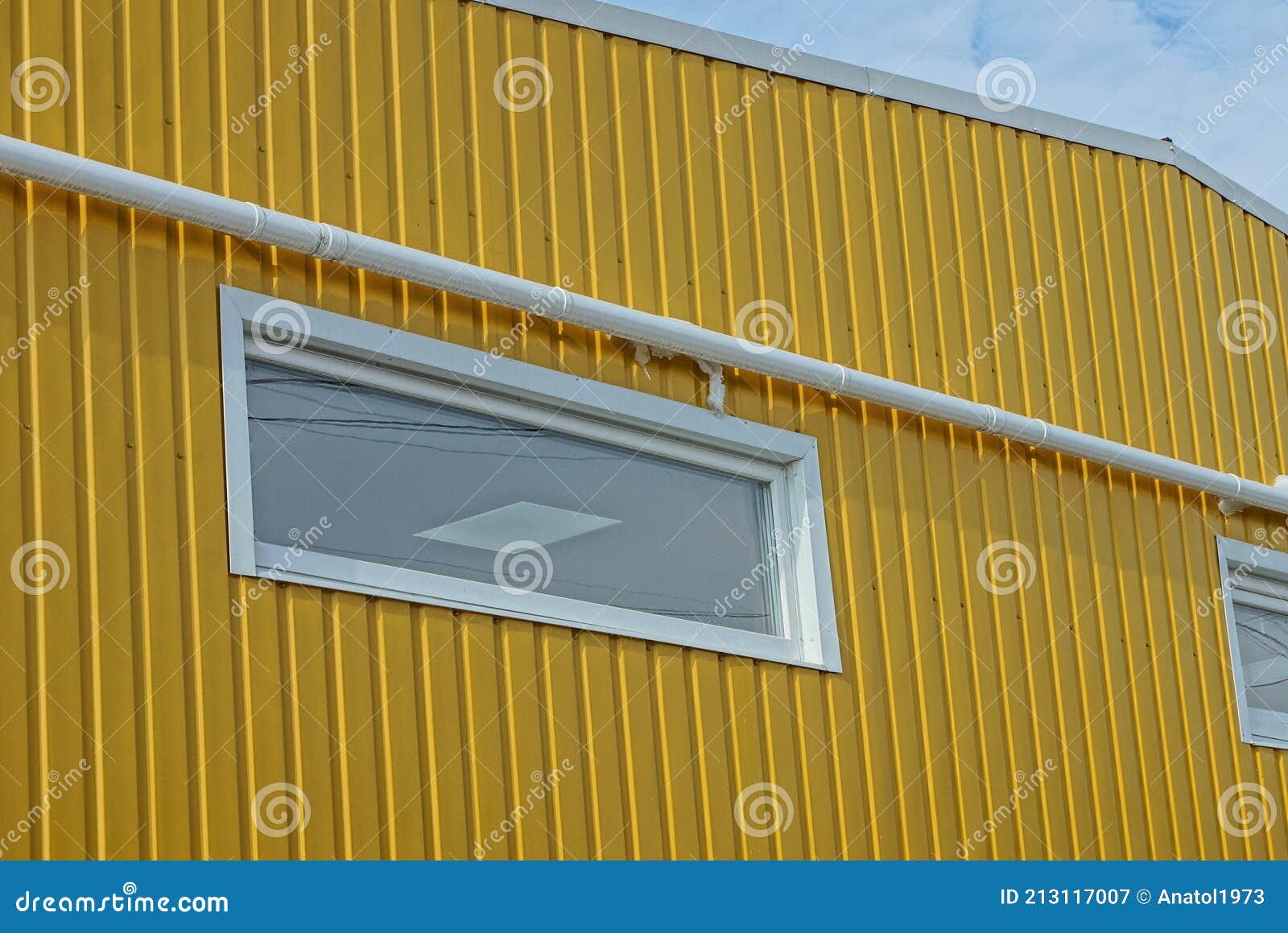 One Small White Rectangular Window on a Yellow Metal Wall of a Building ...