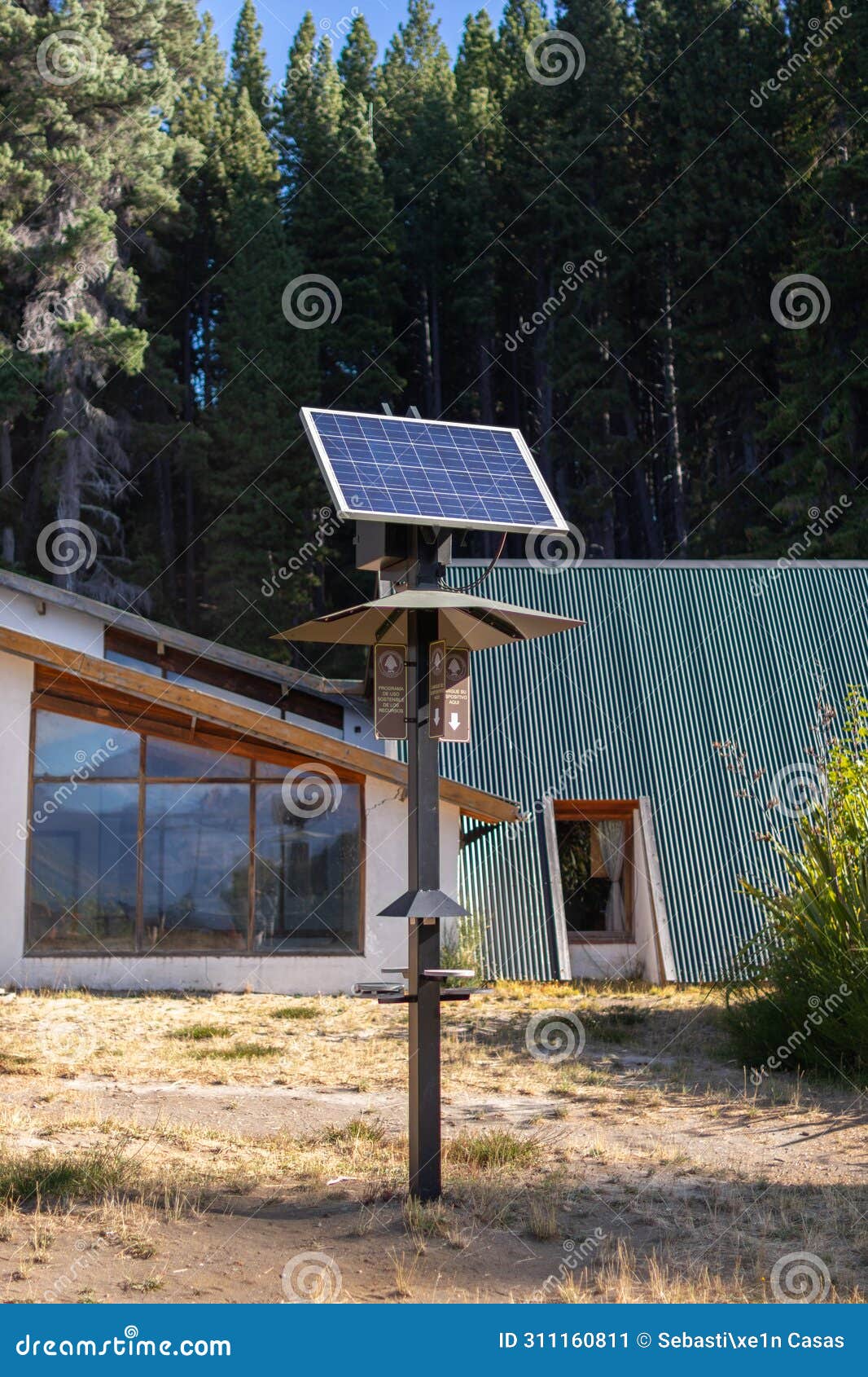 One Solar Panel in a Pole Near a Modern House in the Middle of a Forest ...