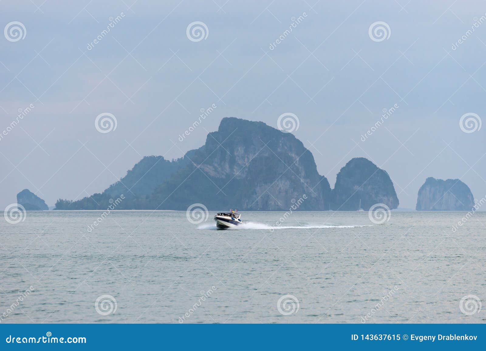 Speedboat in the Sea Water Against the Large Cliff on Background ...