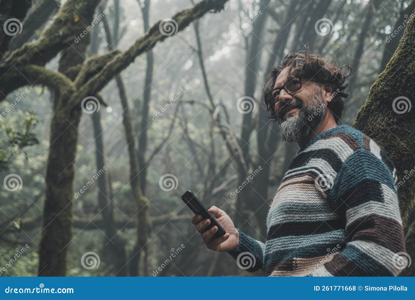 One Standing Man Alone in the Forest Woods Smiling and Using Mobile App ...