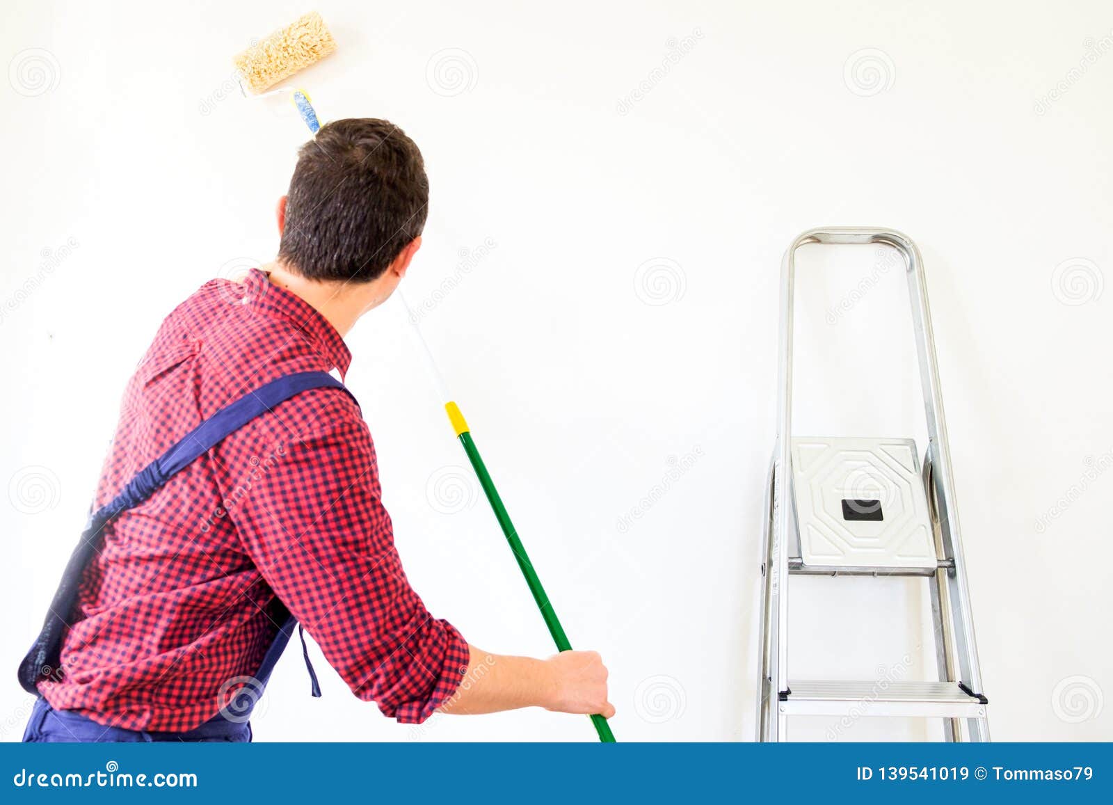 Young Man Painting Wall with White Paint and Tools Stock Image - Image ...