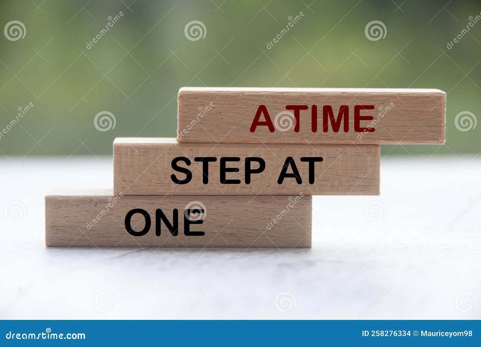 One Step at a Time Words on Wooden Blocks with Blurred Nature ...