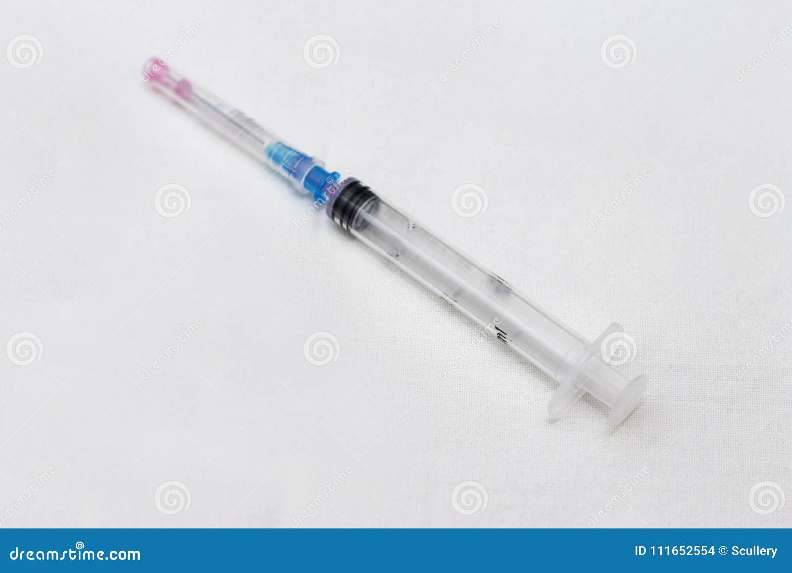 One Syringe with Cap and Needle after Using on the White Bckground ...