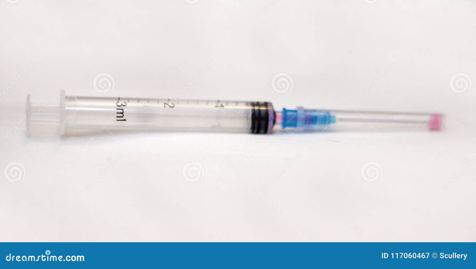 One Syringe with Cap and Needle after Using on the White Bckground ...