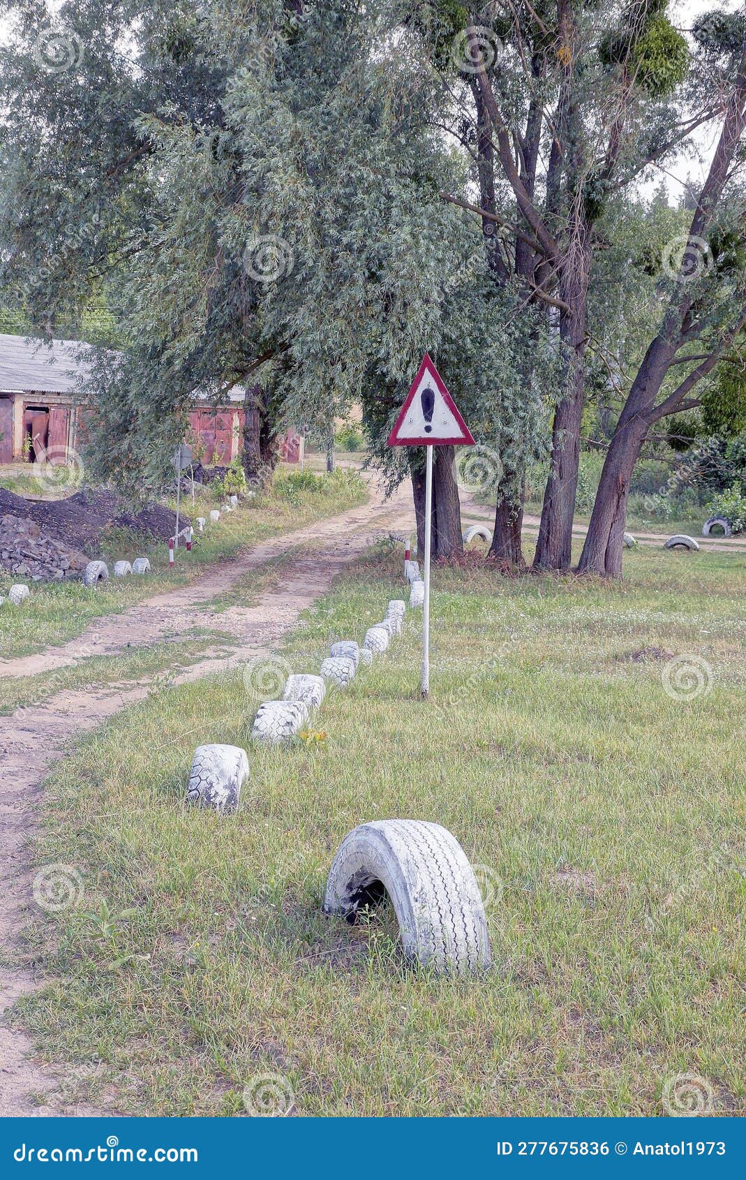 One Triangular Road Sign with an Exclamation Mark Stands by the Road ...