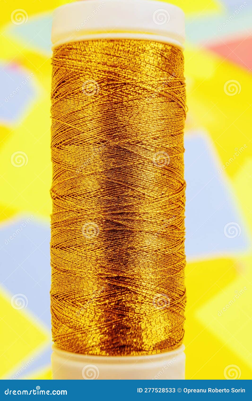 One Twisted Cylindrical New Clean Bobbin Full of Golden Synthetic ...