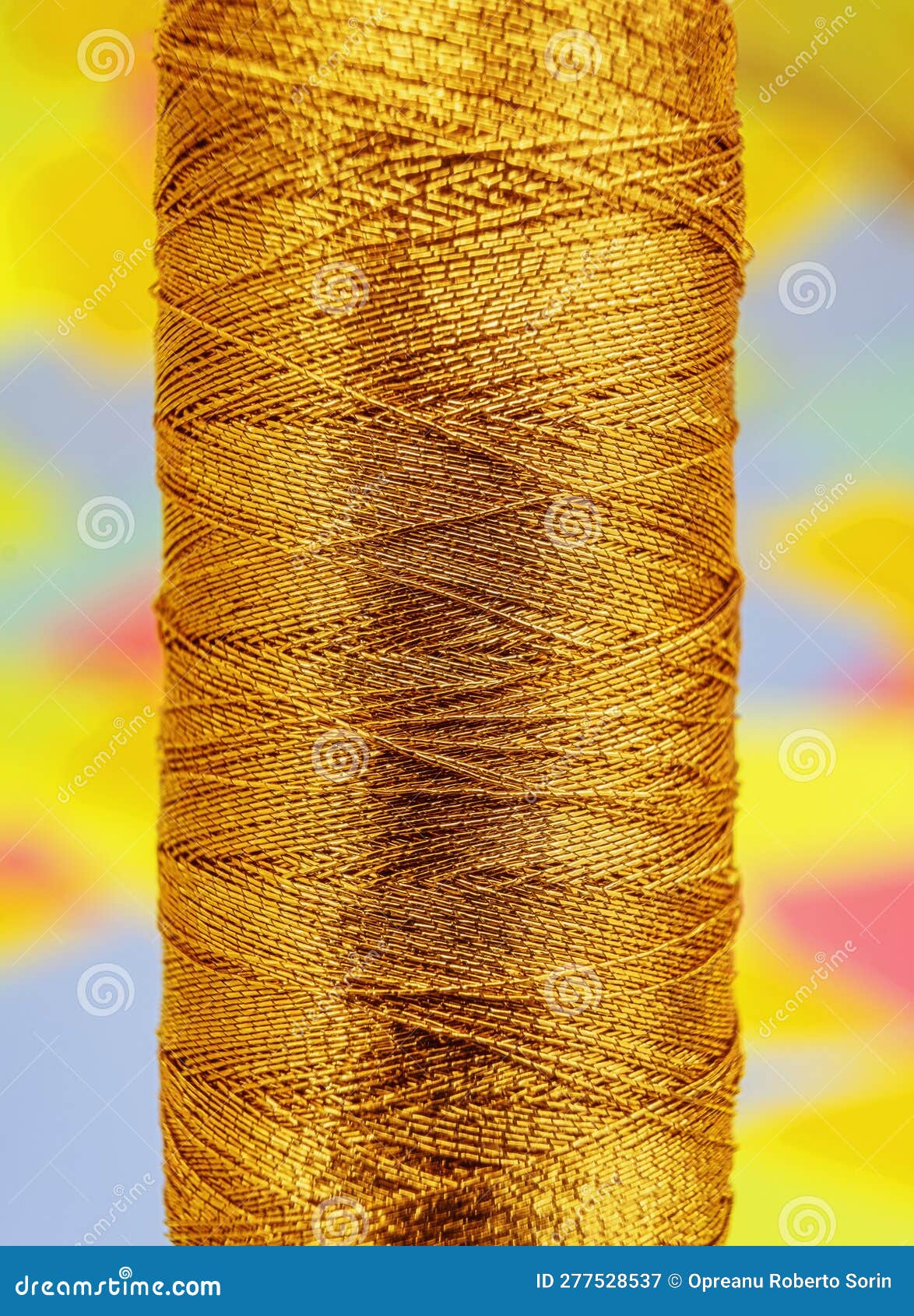 One Twisted Cylindrical New Clean Bobbin Full of Golden Synthetic ...