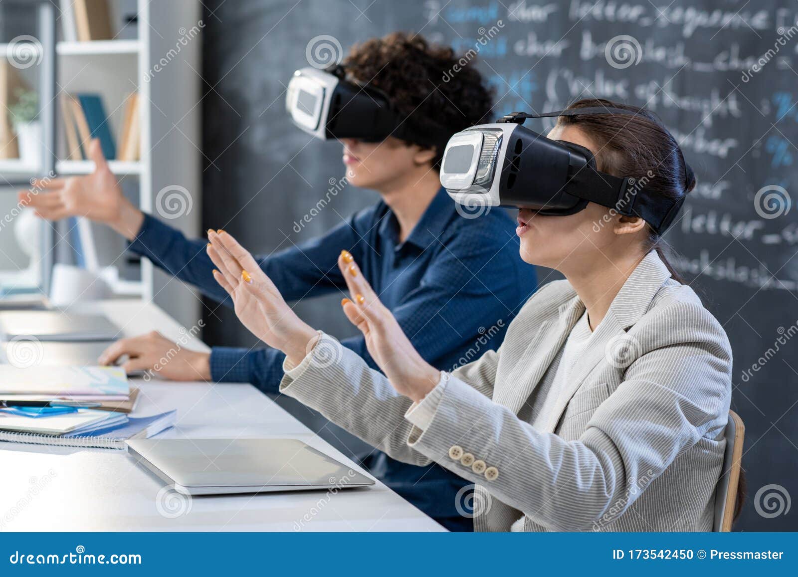 One of Two Students in Vr Headsets Touching Virtual Display during ...