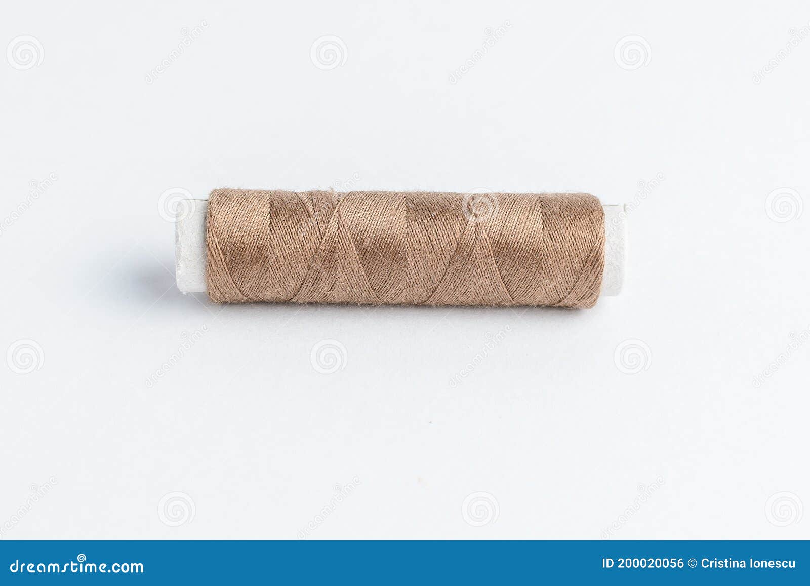 One Vivid Brown Cotton Spool of Thread Isolated on a White Table Stock ...