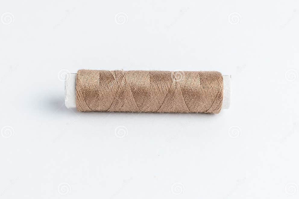One Vivid Brown Cotton Spool of Thread Isolated on a White Table Stock ...