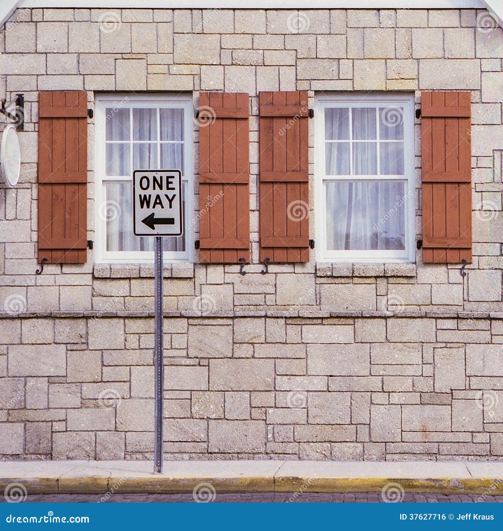 One Way Sign in Front of Windows Stock Photo - Image of limestone ...