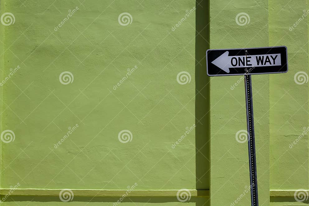 One Way Sign & Green Wall Stock Image - Image of leaning, outside: 25841087