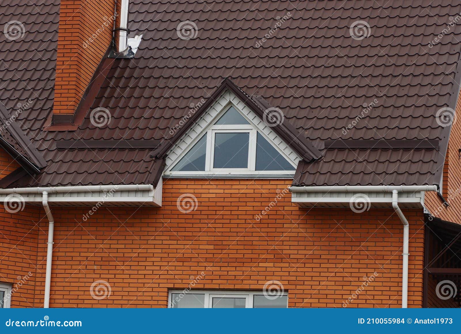 One White Triangular Window on a Red Brick Wall of the Attic of a ...