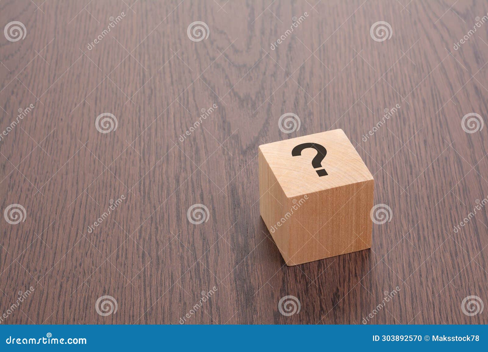 One Wooden Block with Question Mark Over a Brown Background with Copy ...