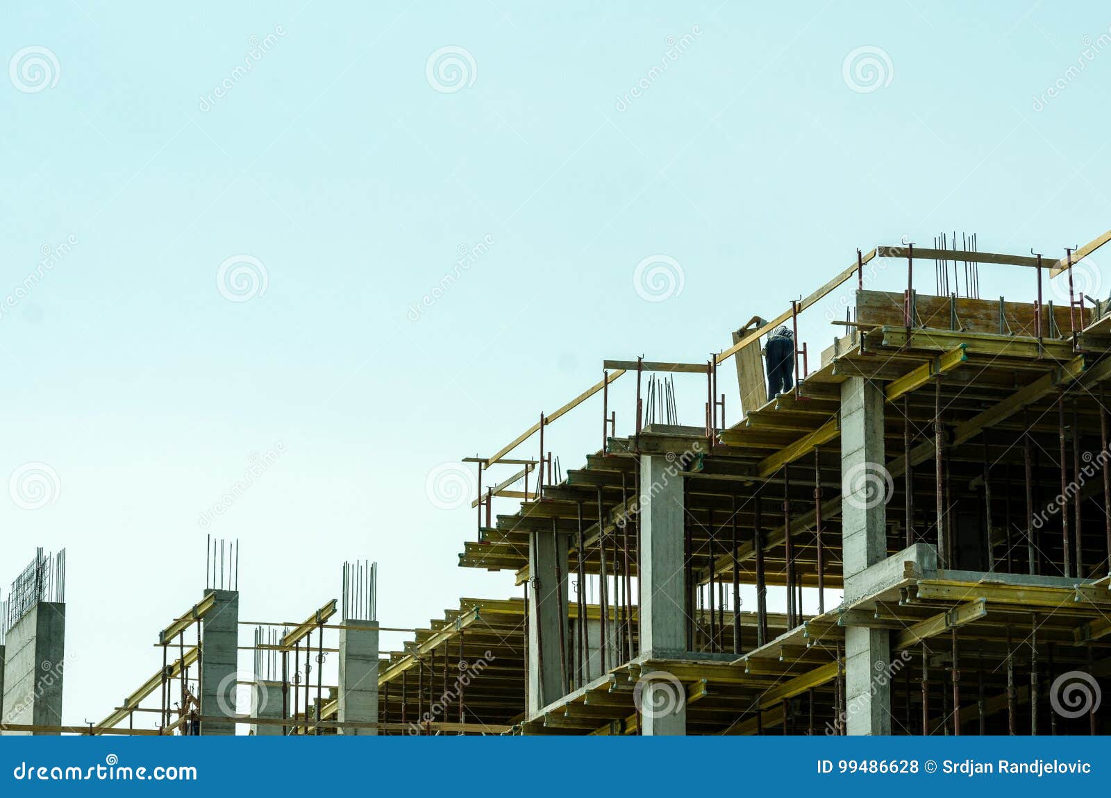 One Worker Working on the Top of the Building Construction Site with ...