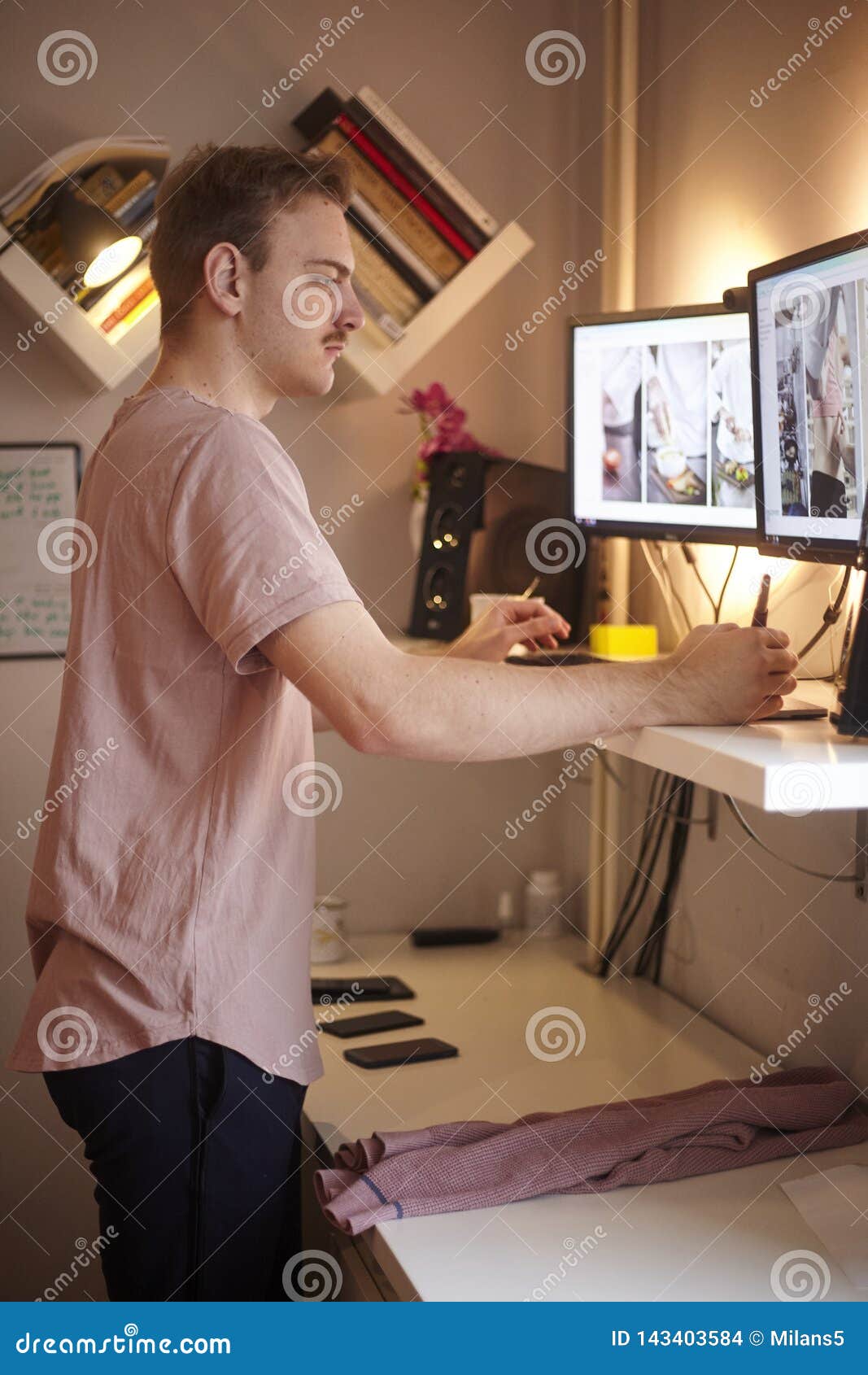 One Young Man, 20-29 Years Old, Looking To Two Computer Monitors, while ...