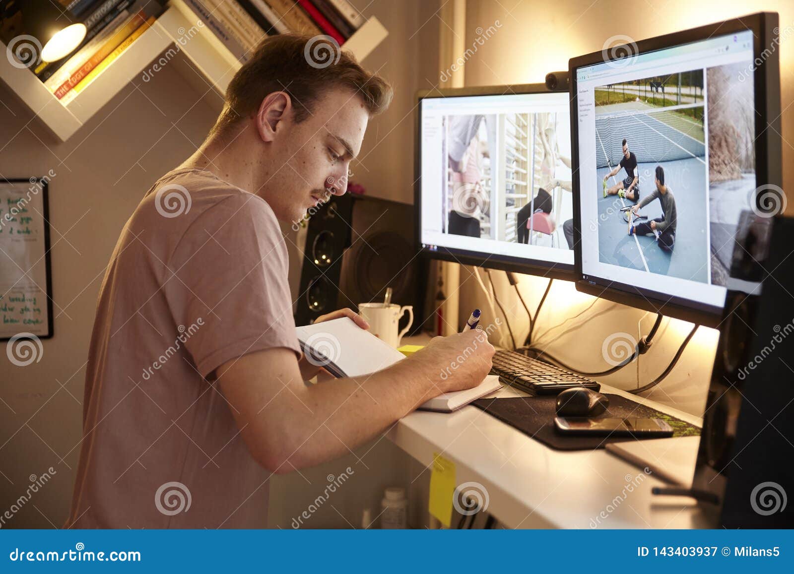 One Young Man, 20-29 Years Old, Writing in His Notebook while in a Room ...