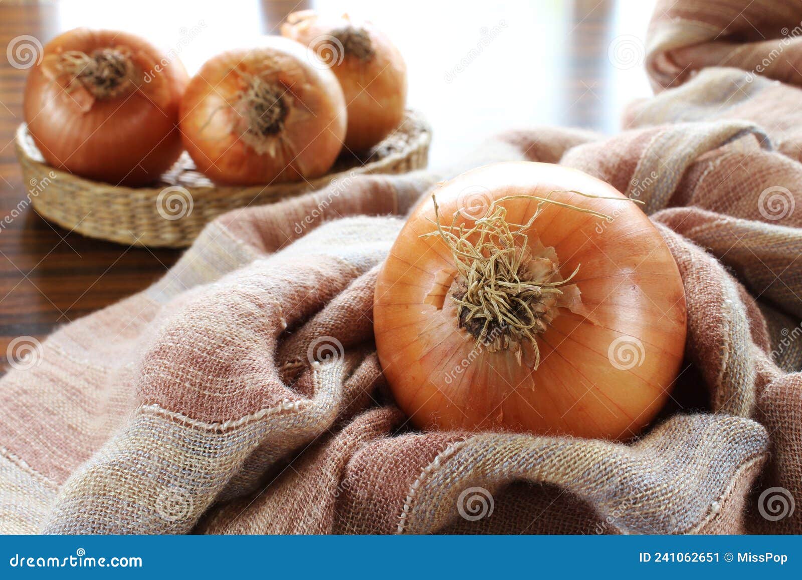 Onion Closeup on the Fabric with Onions Basket in the Background. Stock ...