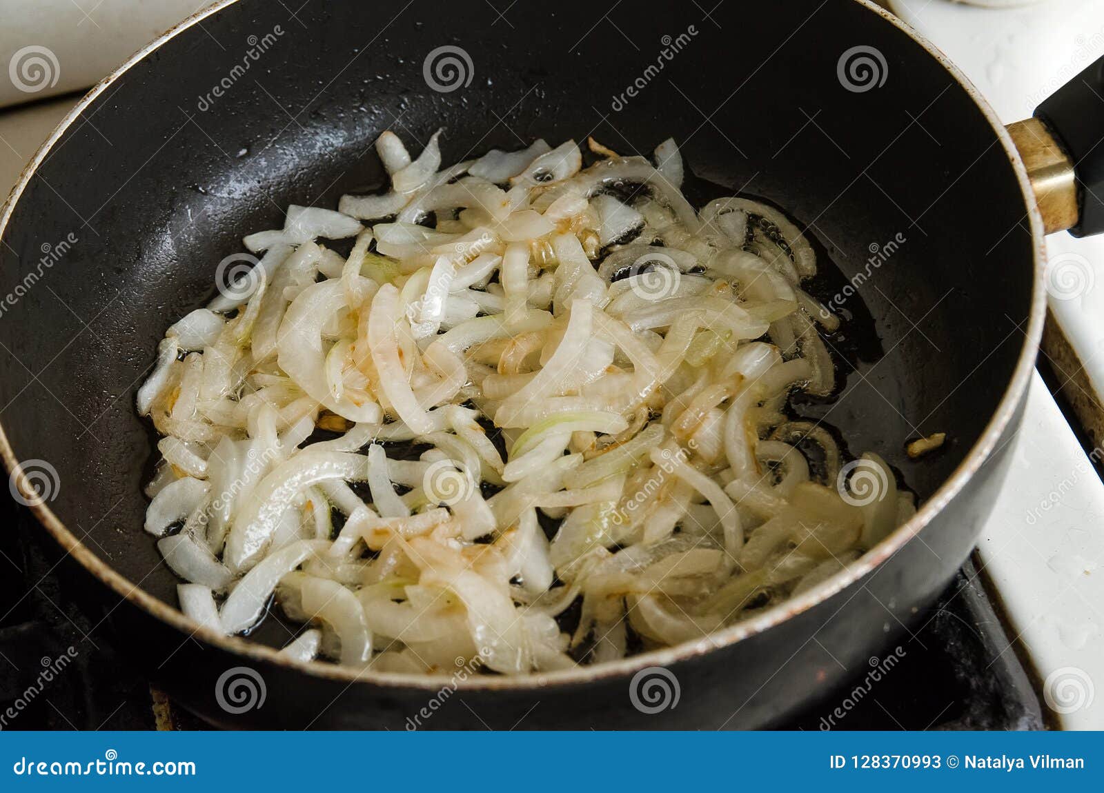 Onion is fried in a pan stock image. Image of ingredient - 128370993