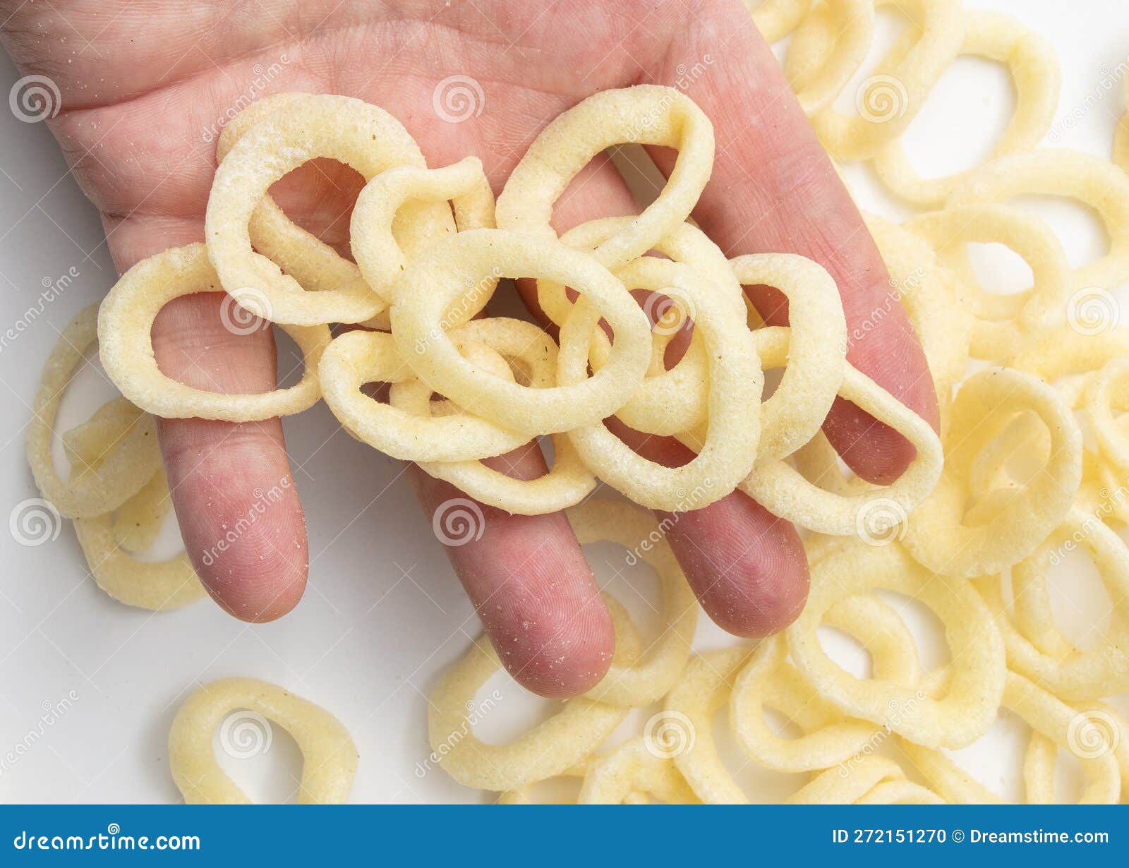 Onion ring chips in hand. stock photo. Image of board - 272151270