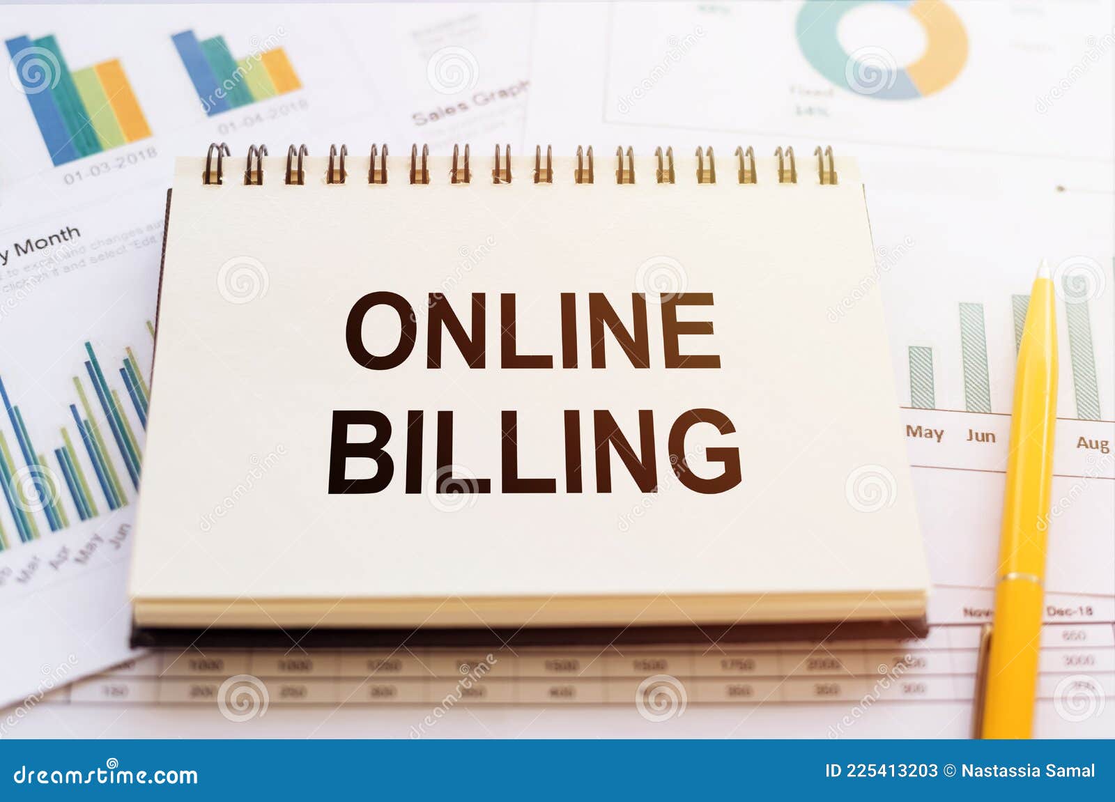 ONLINE BILLING Written on Notepad on Financial Charts and Graphs with ...