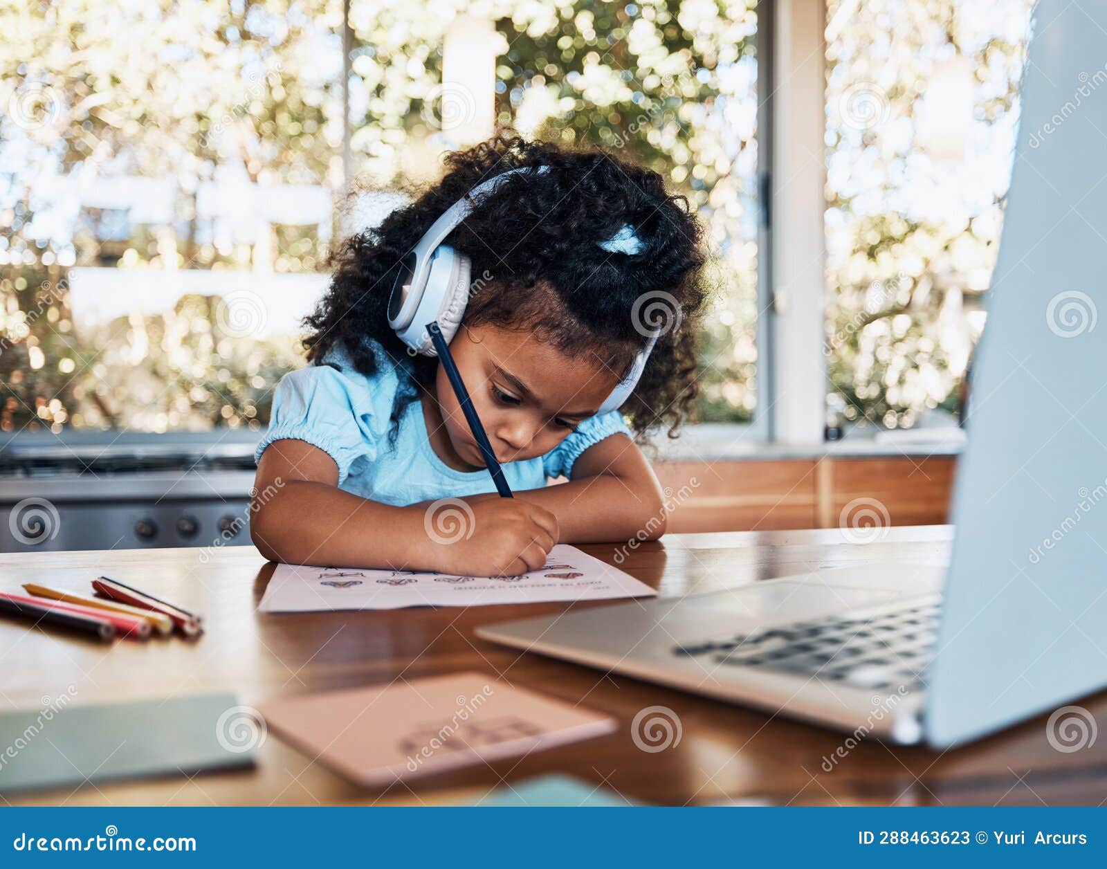 Online Learning, Headphones and Child Writing Assessment at Desk for ...