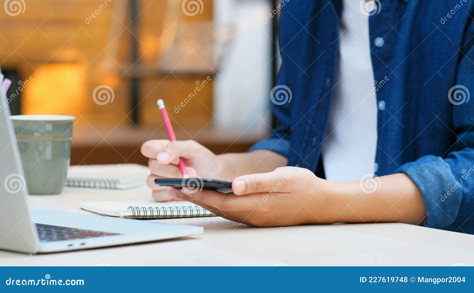 Online Study, Man Hand Writing on Notebook while Using Mobile Phone for ...