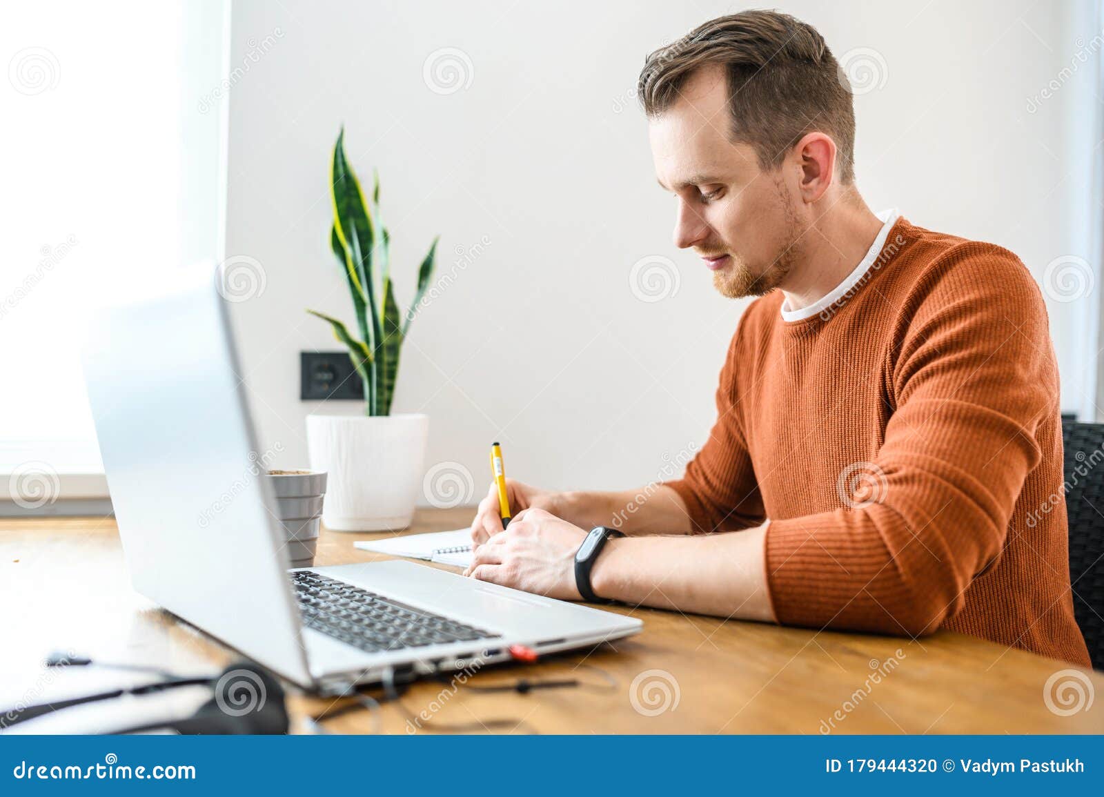 Guy Looks at Laptop and Notes in Notebook Stock Photo - Image of ...