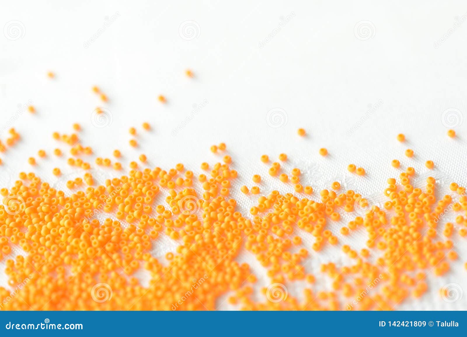 Opaque Seed Beads Orange Color Scattered on a Textile Background Stock ...