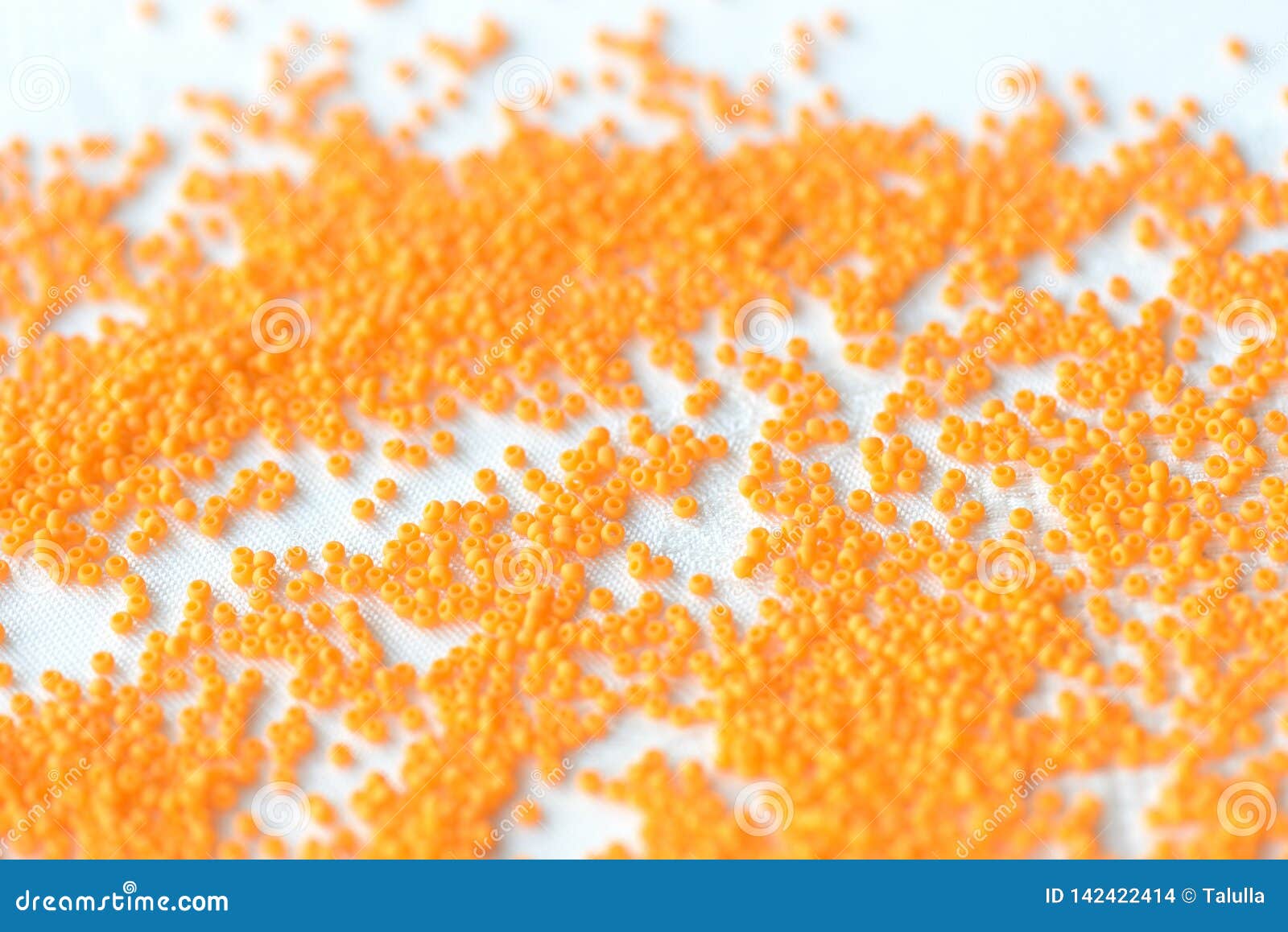 Opaque Seed Beads Orange Color Scattered on a Textile Background Stock ...
