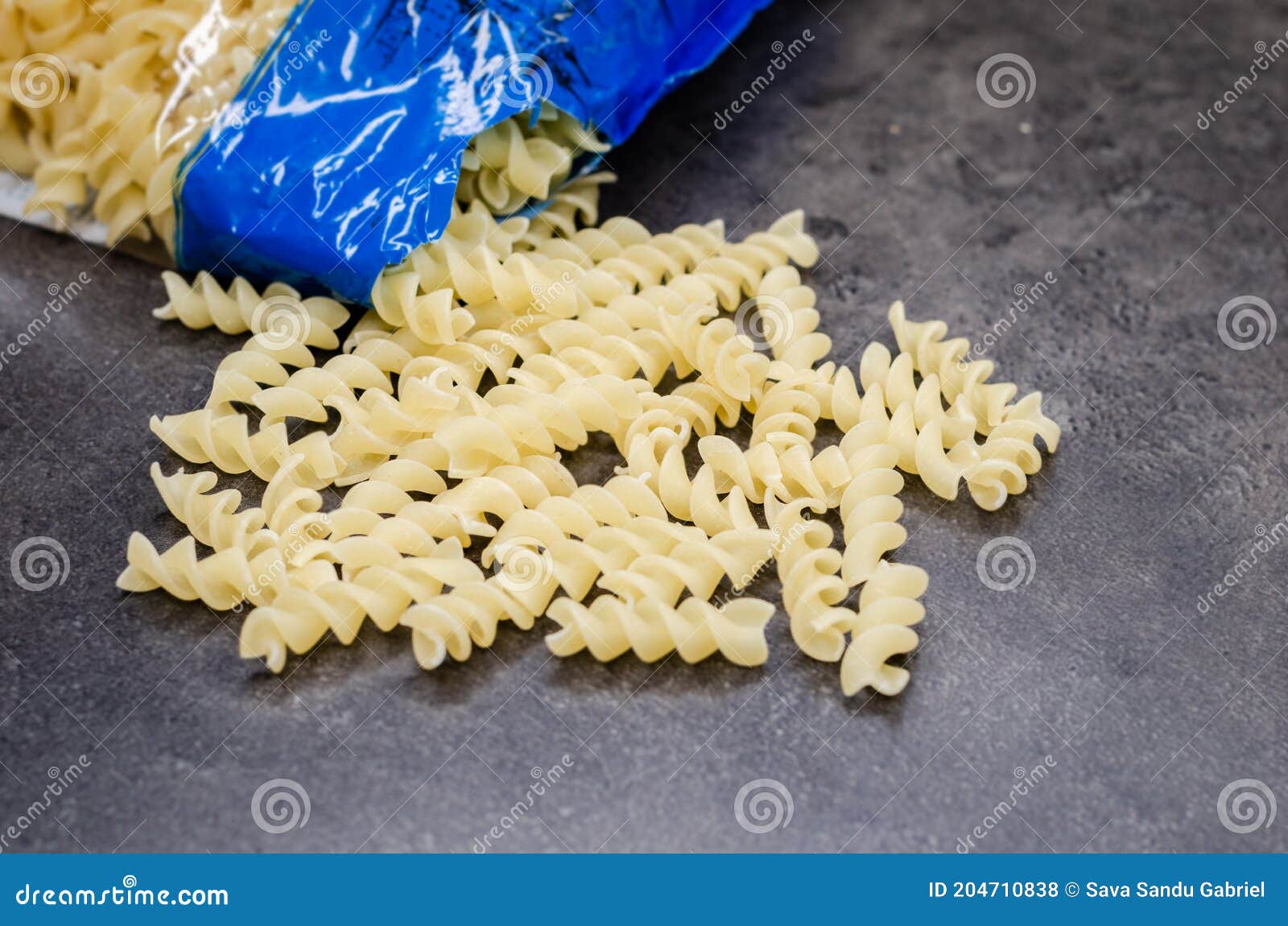 Open Bag with Twisted Pasta on the Table Ready To Cook Stock Photo ...