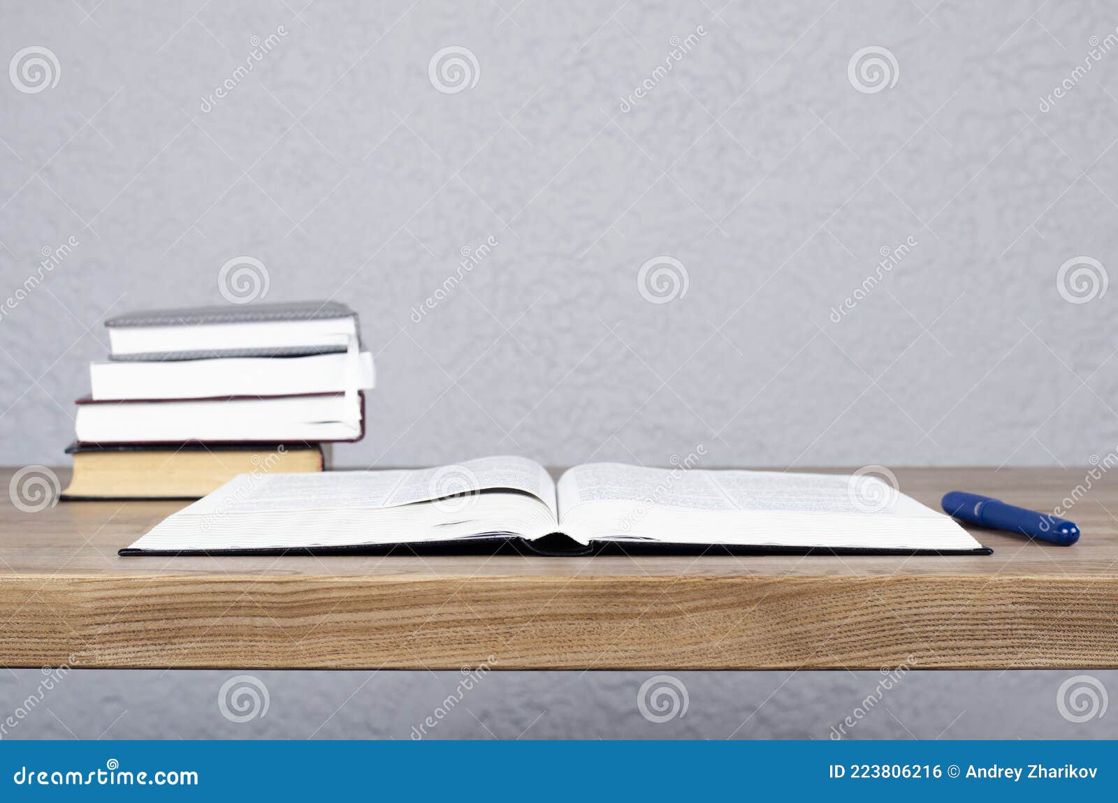 Open Bible. a Stack of Books and a Pen on the Table. Education ...