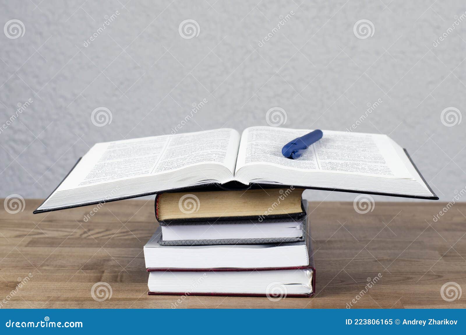 Open Bible. a Stack of Books and a Pen on the Table. Education ...