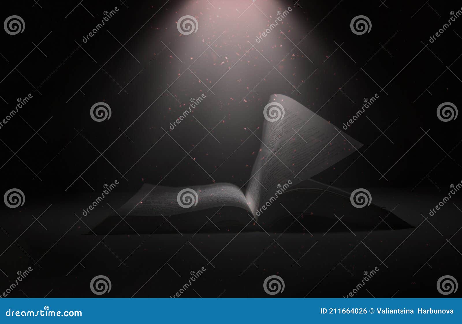 An Open Bible on a Table with Light Coming from Above Stock Photo ...