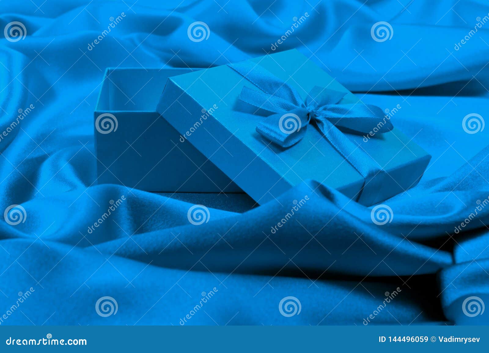 Open Blue Gift Box on Luxurious Blue Silk Stock Image - Image of ...