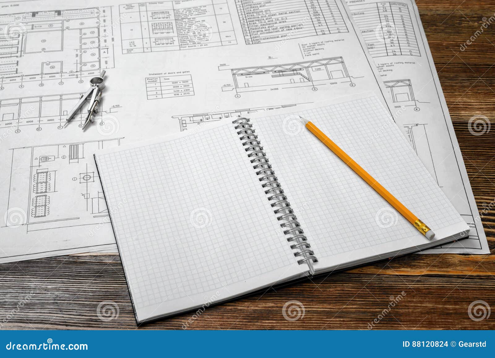 Open Blueprints on Wooden Table Background with a Pencil and Compasses ...
