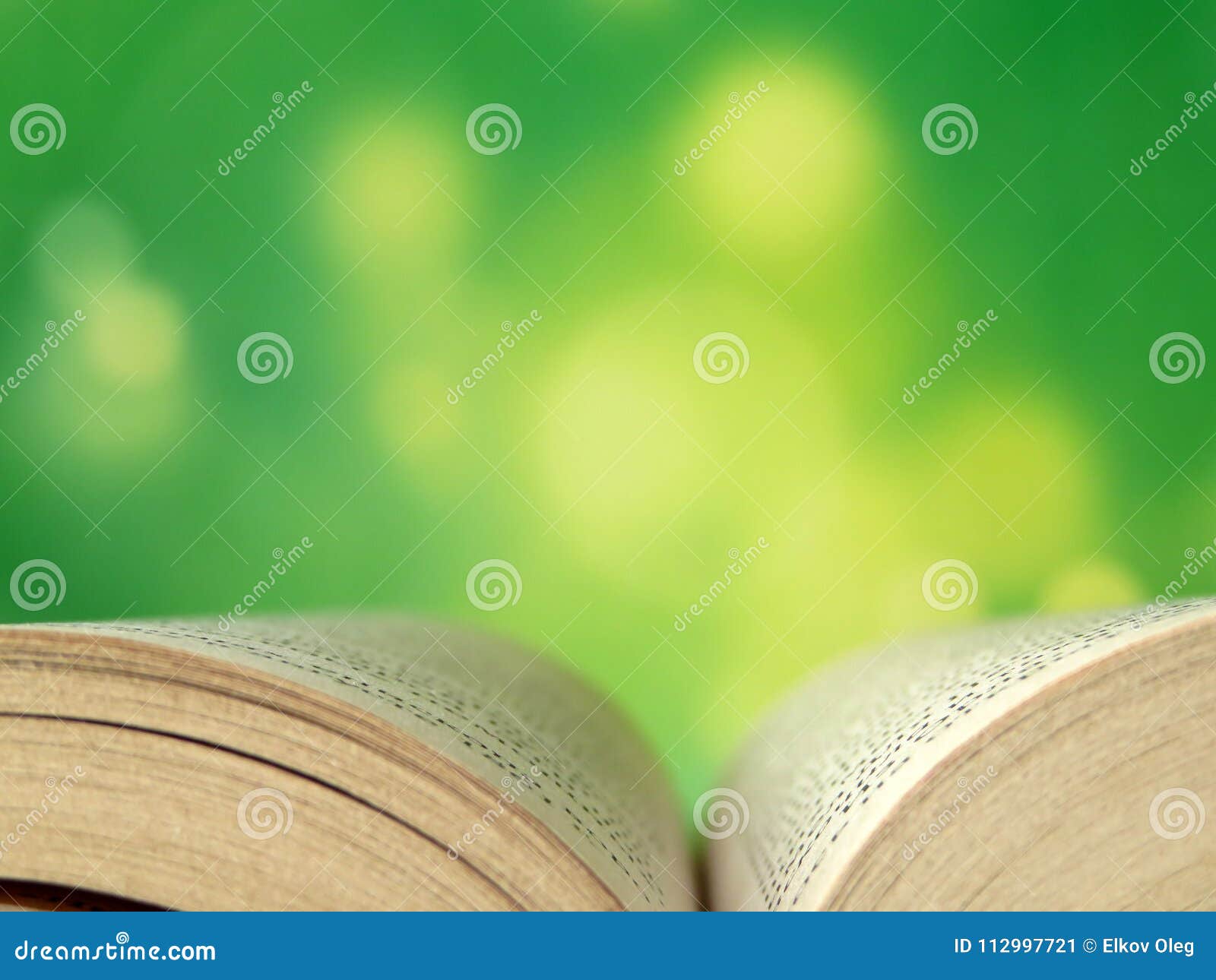 Open Book Against Blurred Green Background Stock Image - Image of ...