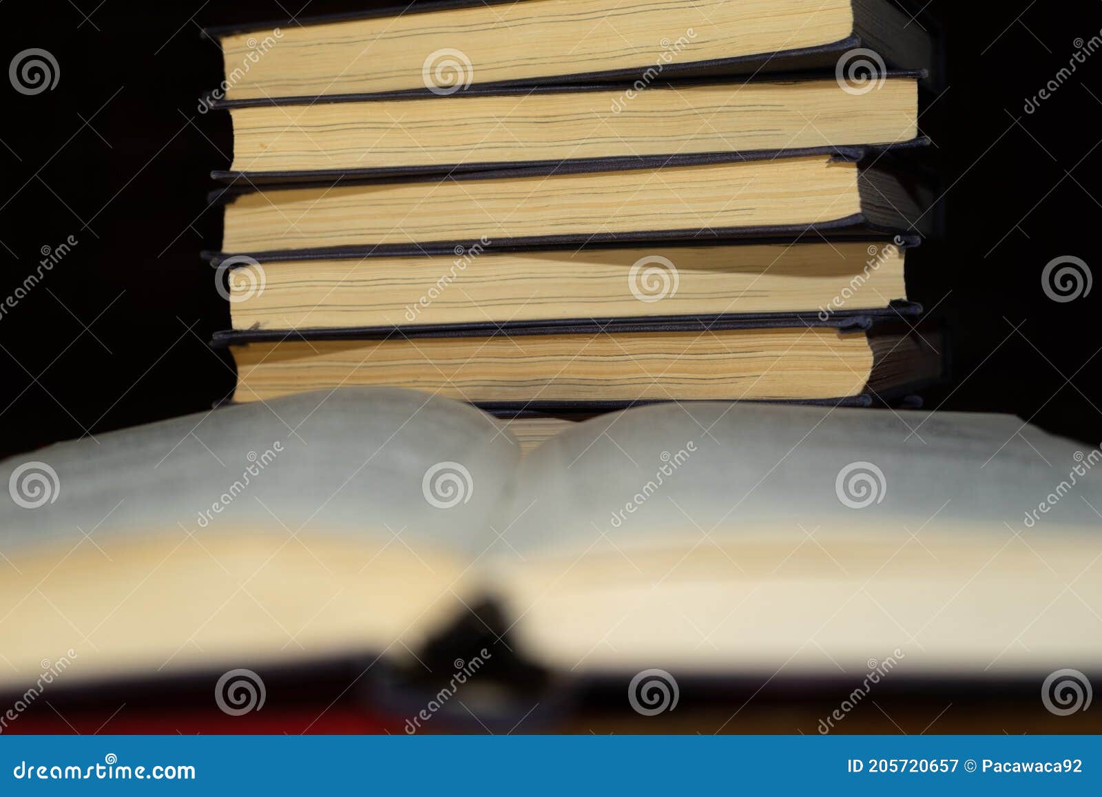An Open Book on the Background of a Stack of Books. Reading a Book ...