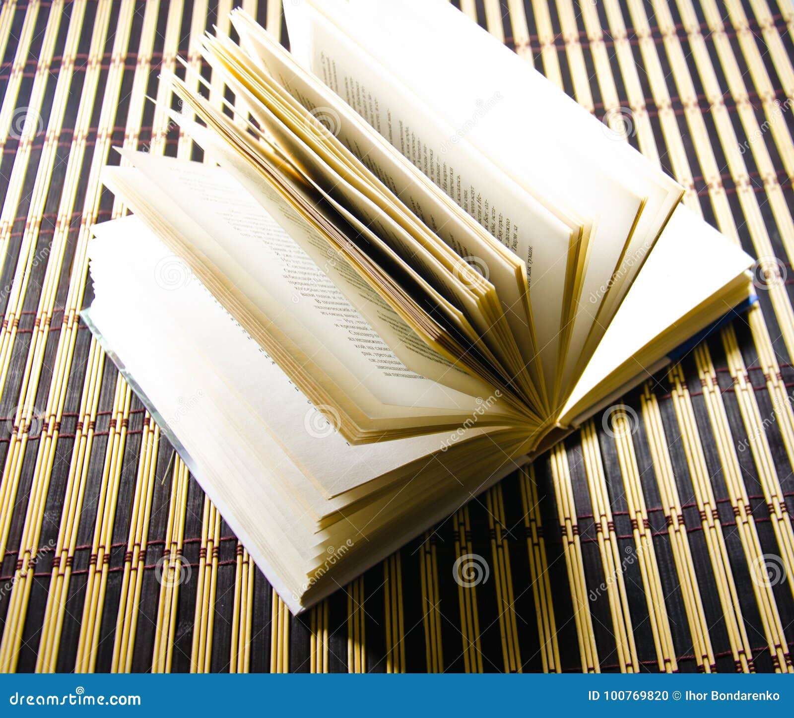 An Open Book on a Bamboo Mat Stock Photo - Image of page, information ...
