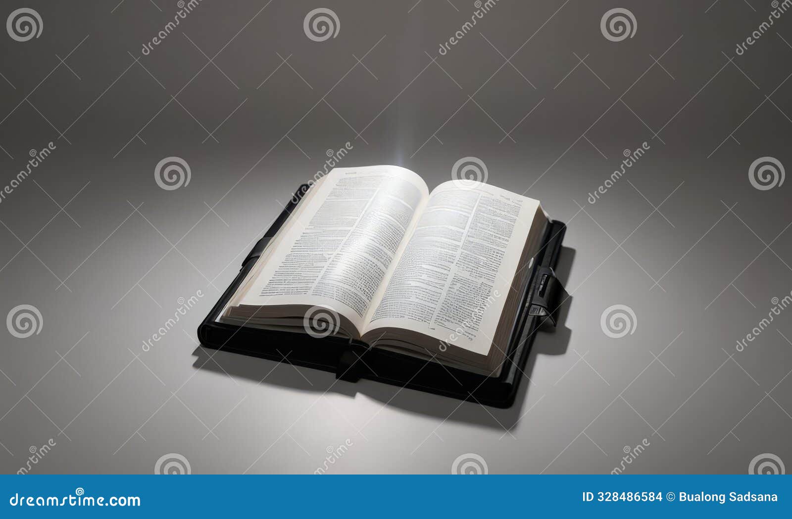 Open Book with Black Cover Rests on Gray Surface, Casting Shadow and ...