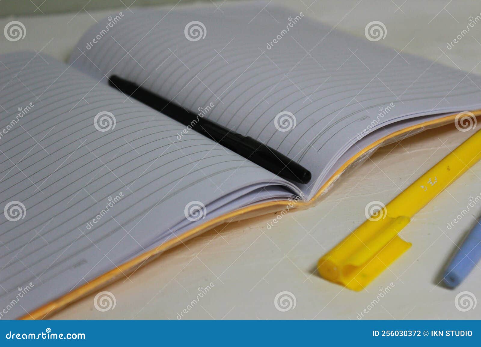 Open Book with Black Lines with Colorful Pencils on a White Table Stock ...