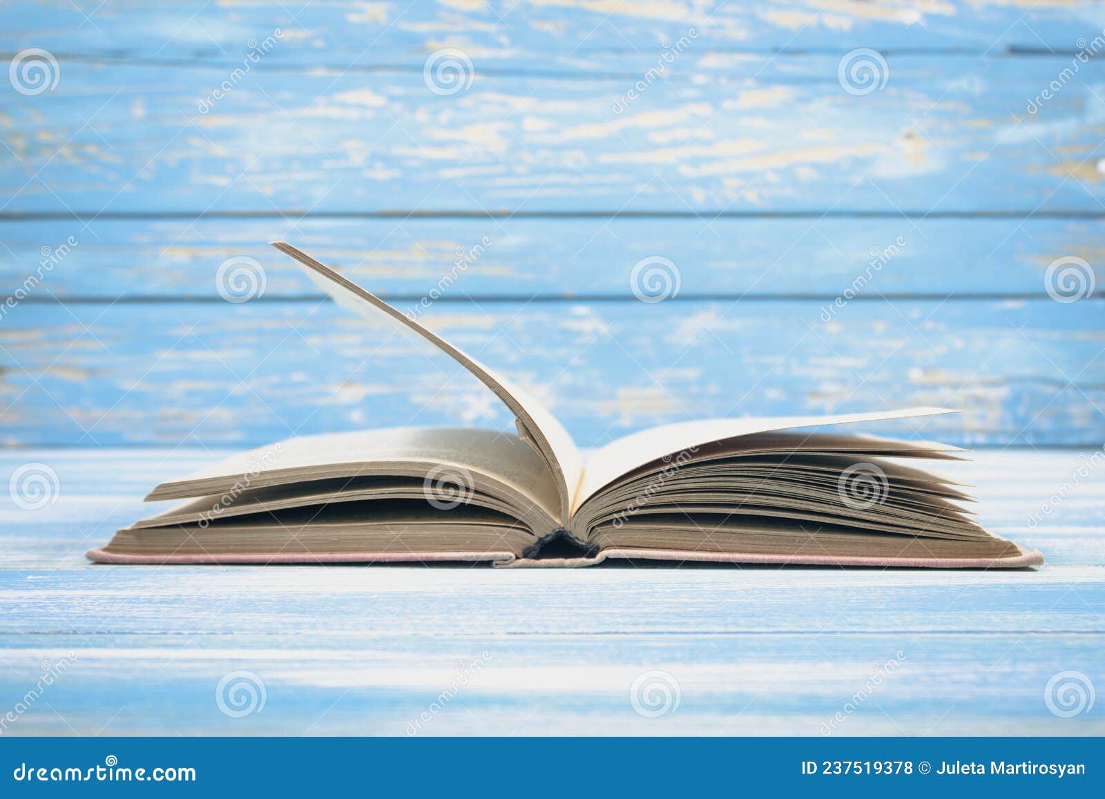 Open Book on Blue Wooden Background Stock Photo - Image of library ...