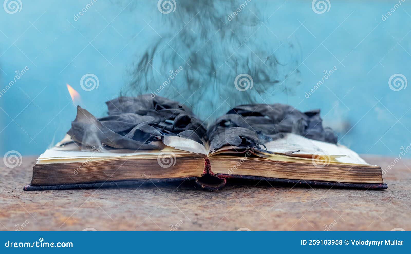 An Open Book with Charred Pages and Smoke from Burning Stock Photo ...