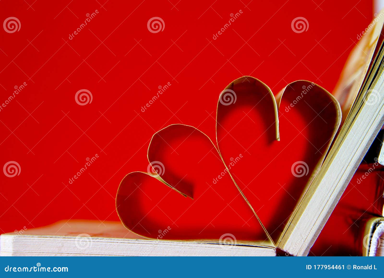 Open Book with a Folded Heart on Red Background Stock Image - Image of ...