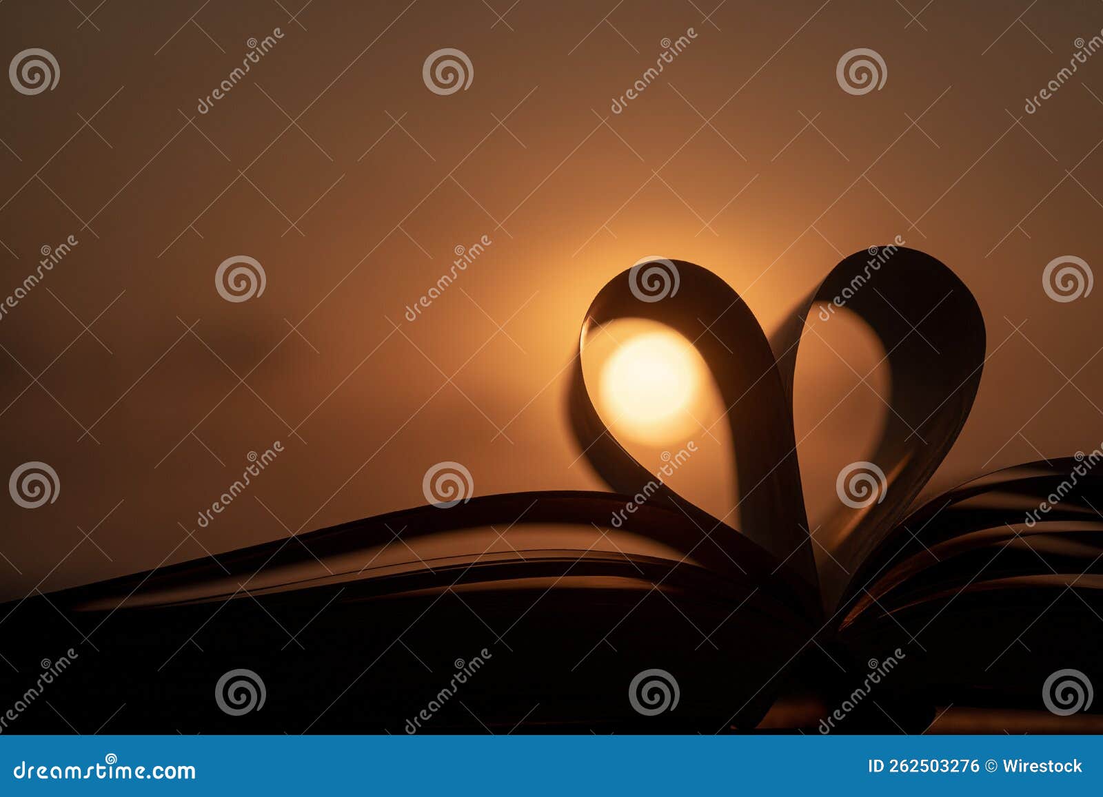 Open Book with Heart-shaped Pages Against a Beautiful Sunset Stock ...