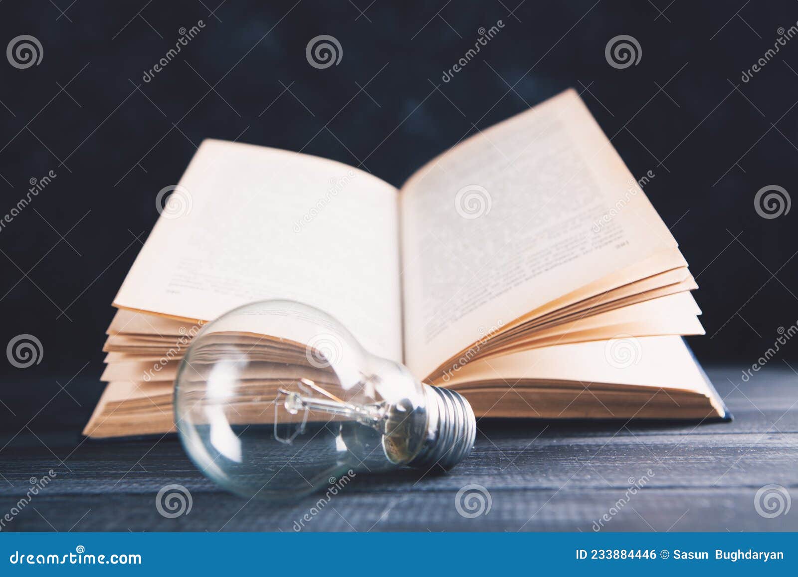 An Open Book and a Light Bulb on the Table Stock Photo - Image of ...